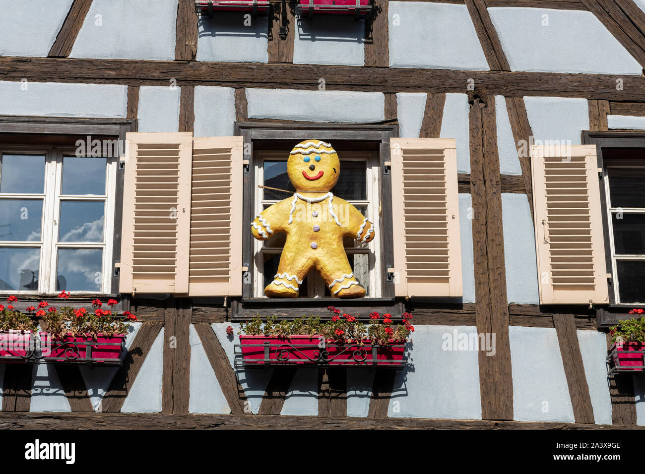 A model gingerbread man in a window in a half timbered old house in ...