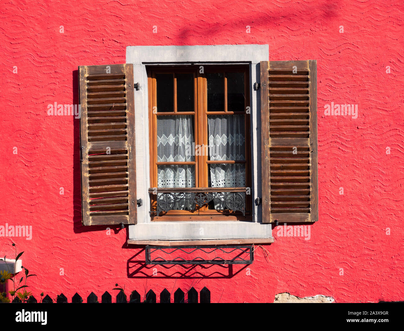 An old shuttered window in a medieval stone building in Eguisheim ...