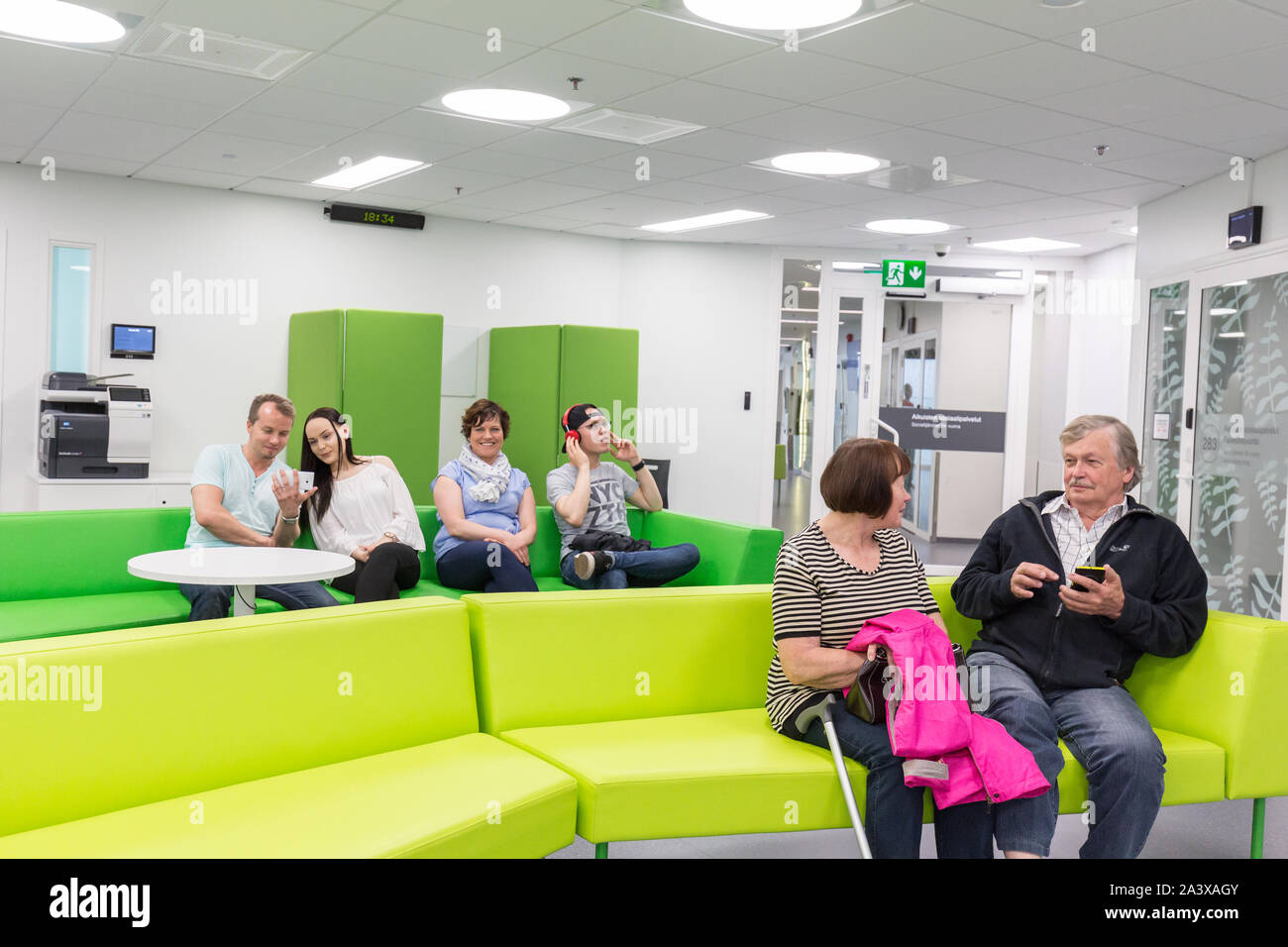 Group of people waiting their turn in a hospital lobby Stock Photo - Alamy