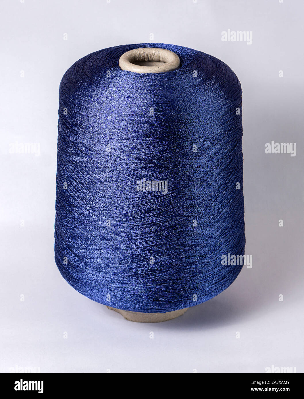 bobbin of yarn on a white background. Side view.Textile reel on ...