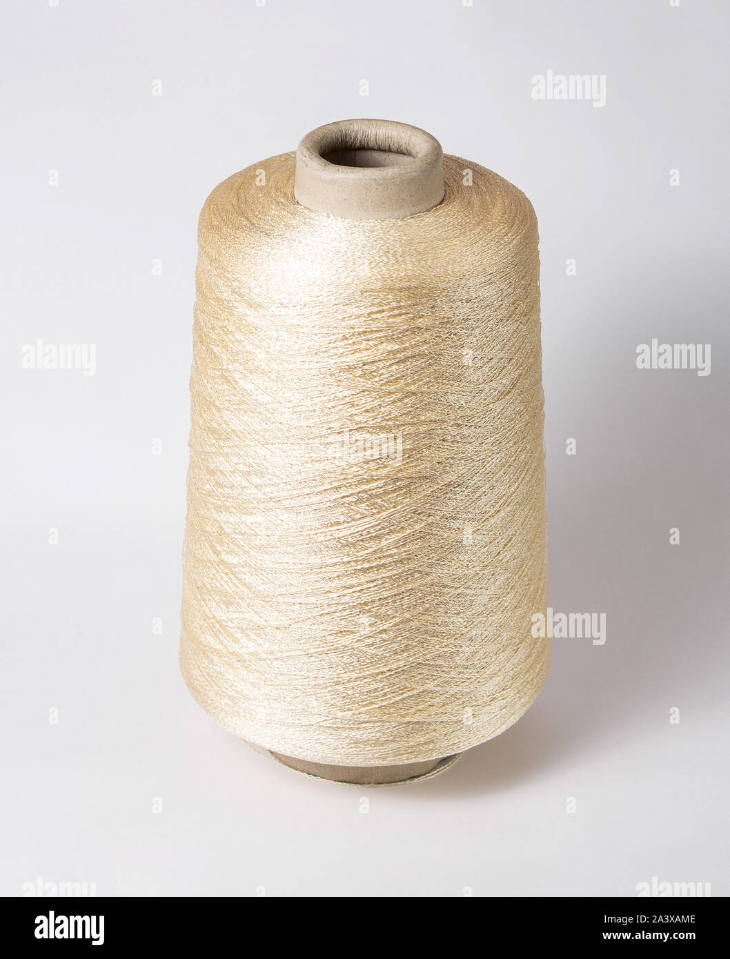 bobbin of yarn on a white background. Side view.Textile reel on ...