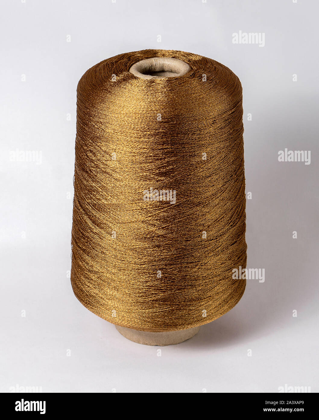 bobbin of yarn on a white background. Side view.Textile reel on ...