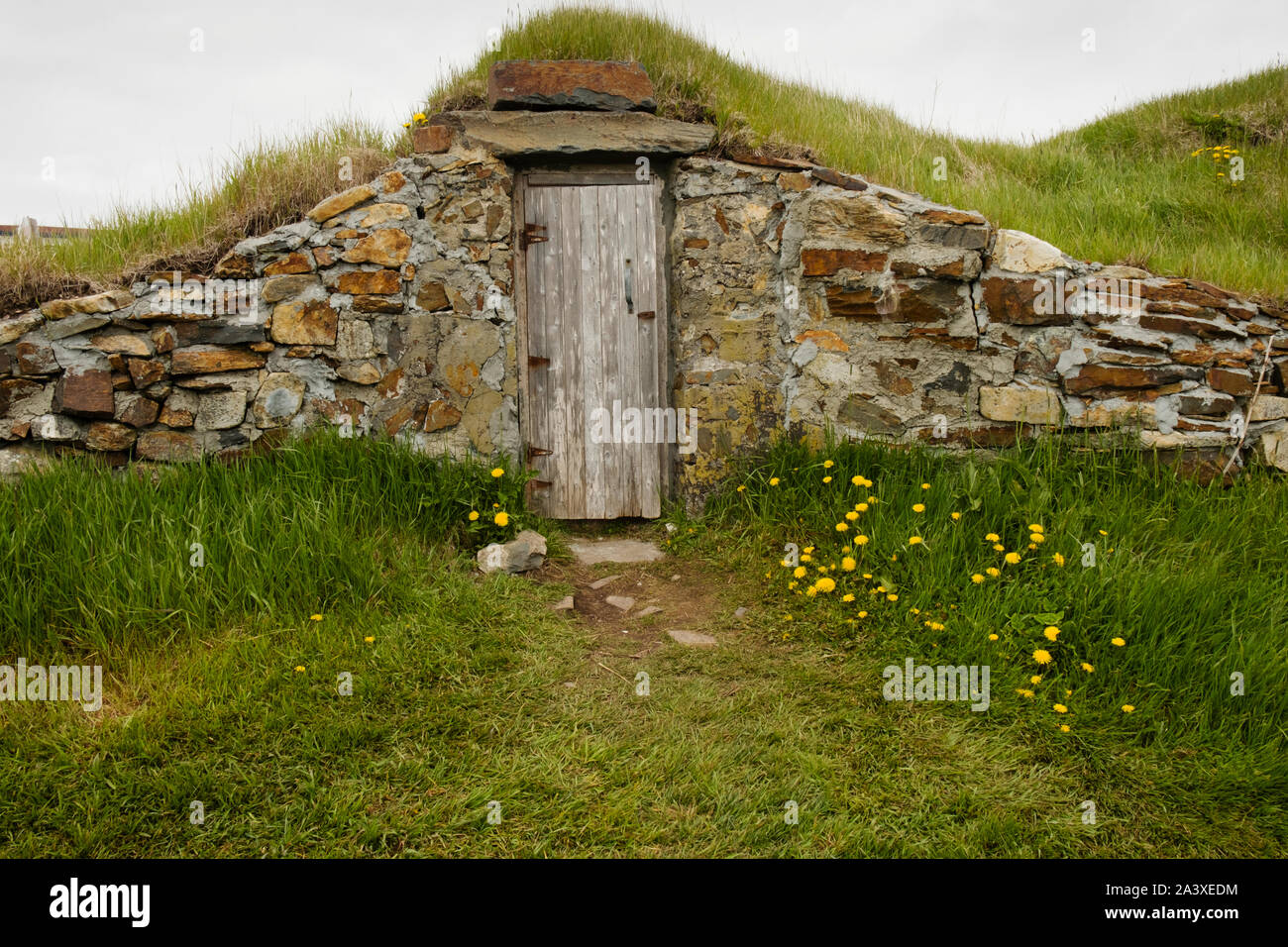 Root cellar made of stone with a wooden door in Elliston, Newfoundland ...