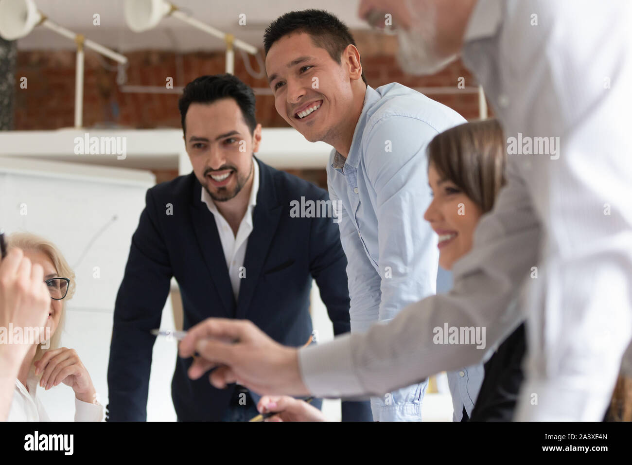 Smiling multiracial colleagues brainstorm hi-res stock photography and ...