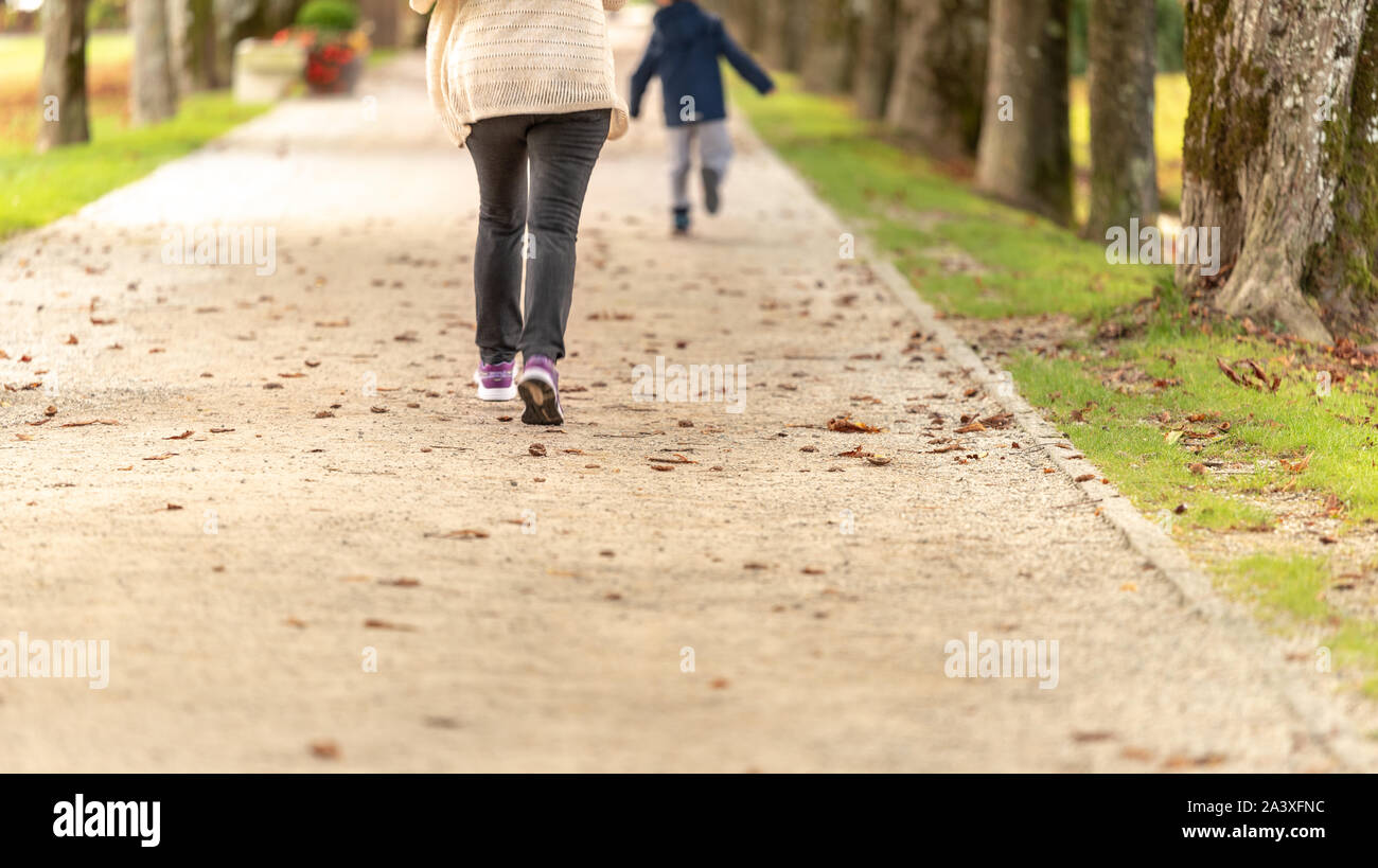 Grandmother and boy running in the park. sunny autumn day, photo in the ...