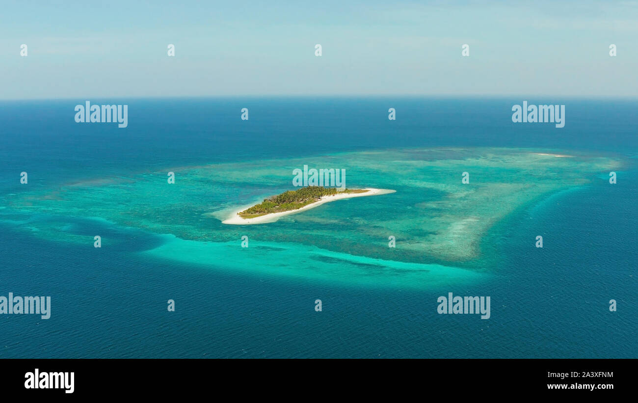 Tropical island Canimeran with sandy beach in the blue sea with coral ...