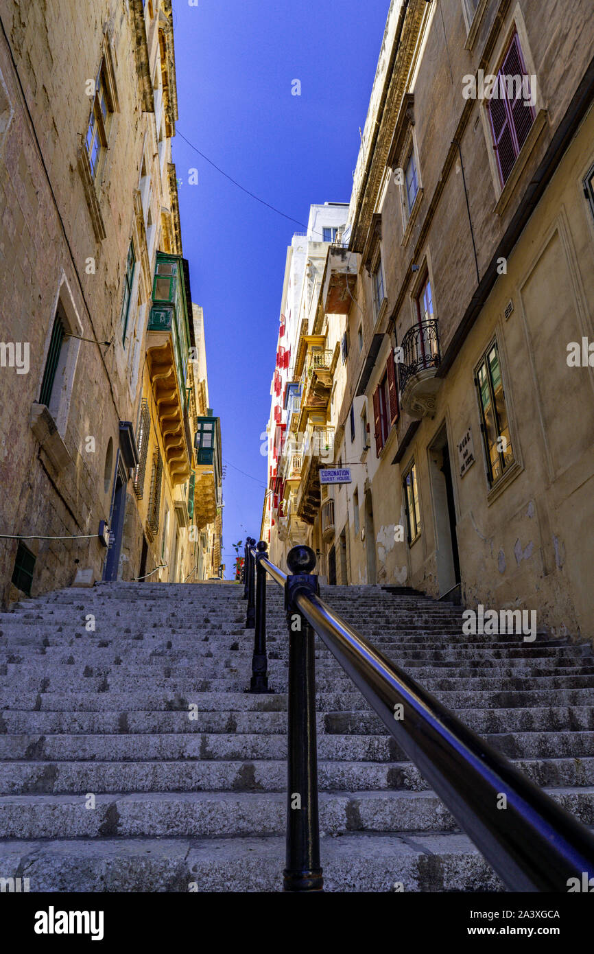 shot of a narrow street with stairs in Valetta Stock Photo - Alamy