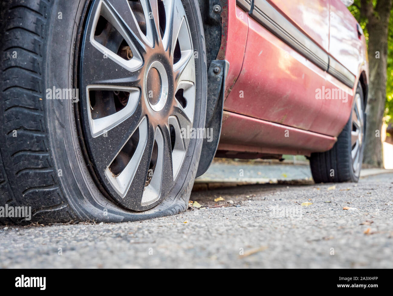 Flat tire on the roadside Stock Photo - Alamy