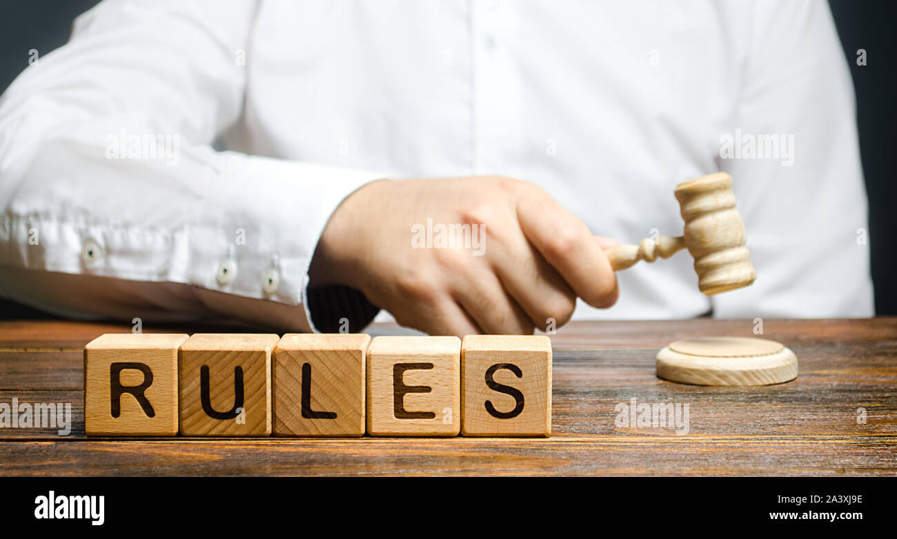 A man knocks a hammer publishes new rules and laws. Setting clear rule ...