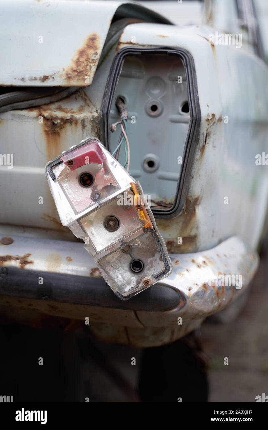 Old rusty white car with broken headlight, close-up Stock Photo - Alamy