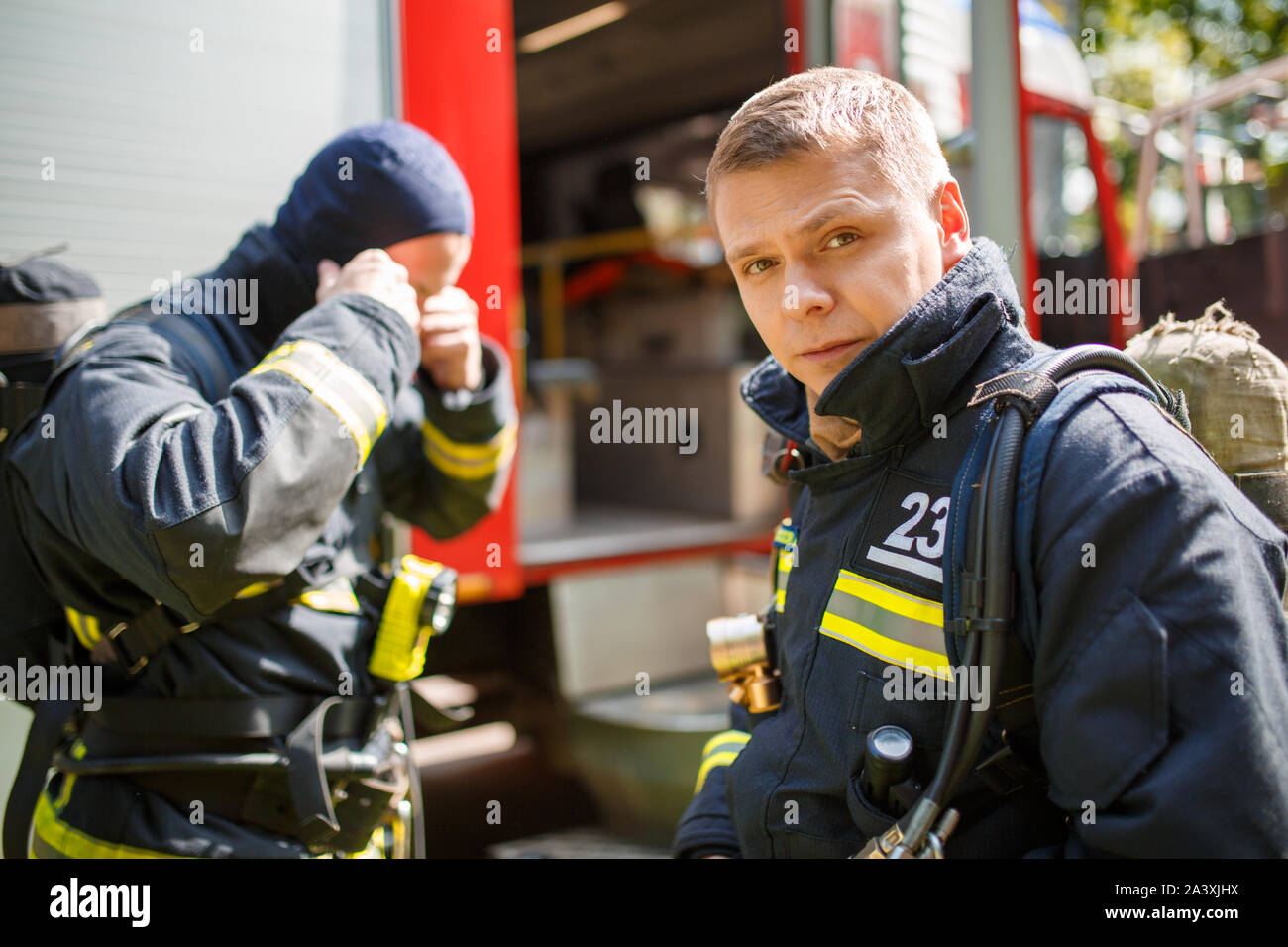 Fire men standing in fire truck hi-res stock photography and images - Alamy