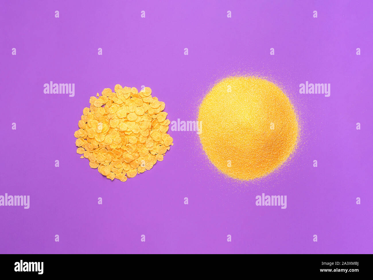 Cornmeal and corn flakes piles on purple background. Nutritious cooking ...