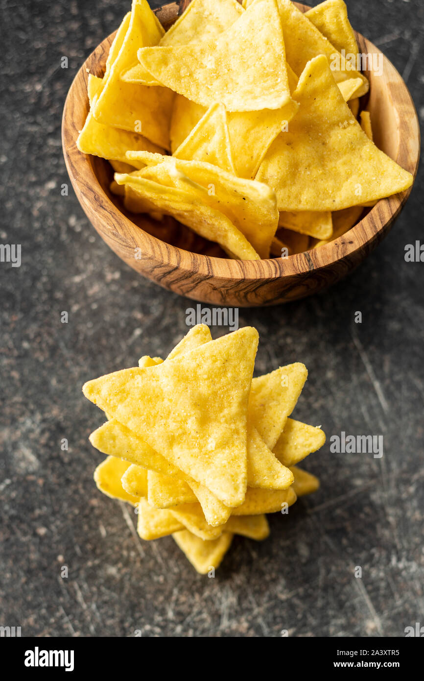 Corn nacho chips. Yellow tortilla chips on old kitchen table Stock ...