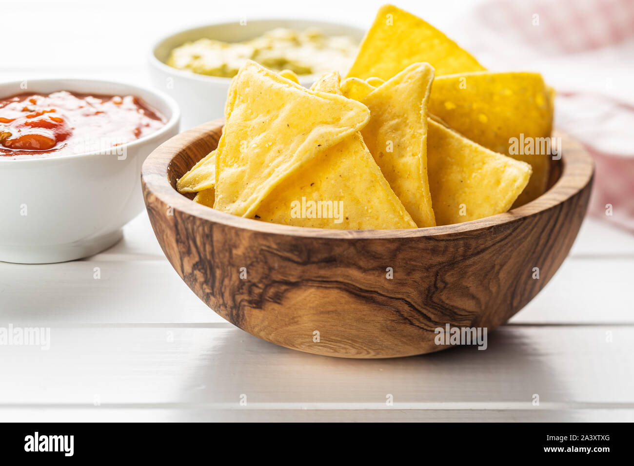 Corn nacho chips. Yellow tortilla chips in wooden bowl Stock Photo - Alamy