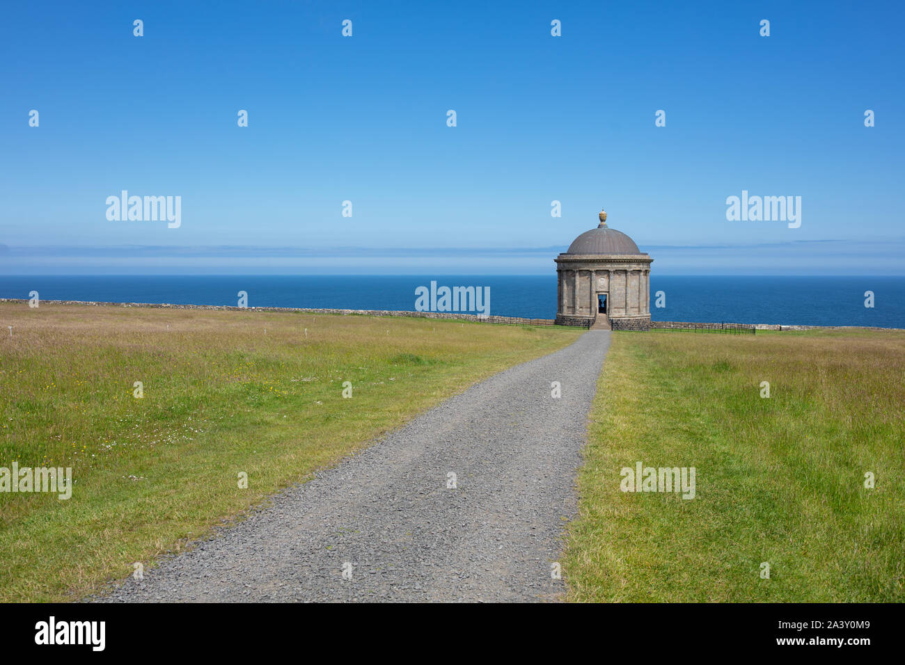 Mussenden Temple against blue sky and Atlantic ocean on the North ...