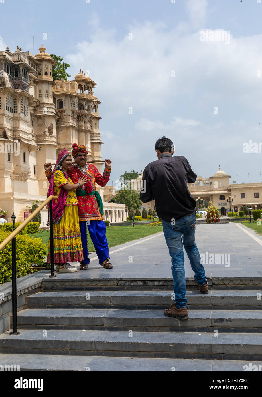 Indian tourists posing in traditional clothing in front of the facade ...