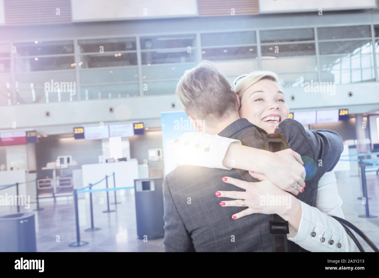 Woman and man passengers hugging each other at the airport Stock Photo ...