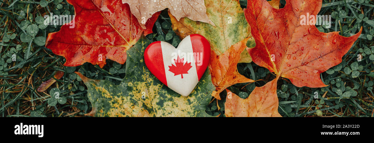 Heart shape wooden national Canadian flag symbol lying on ground in ...