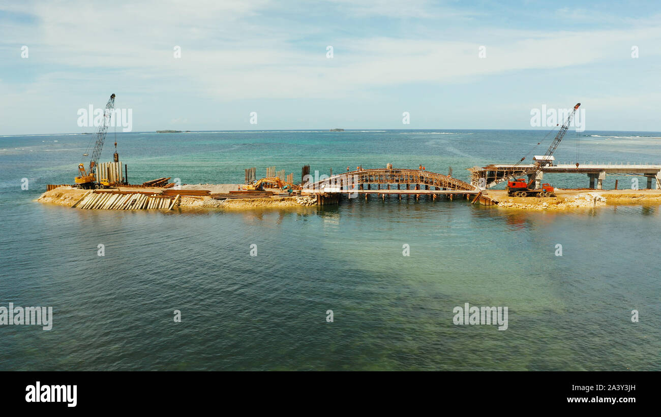 Construction of a new bridge over the sea bay on the tropical island of ...