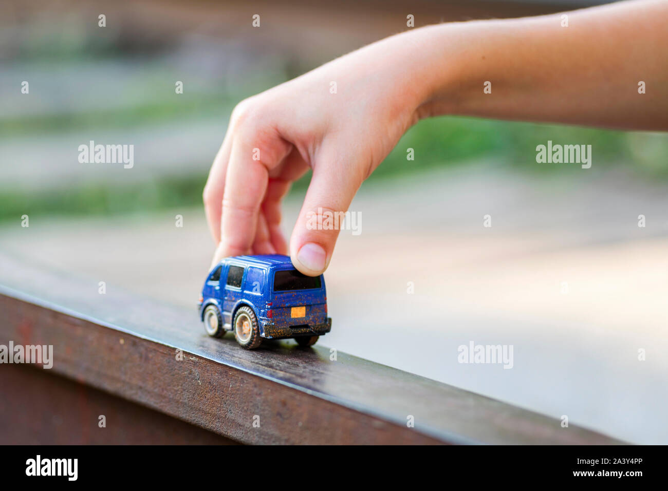 Children kid playing blue color car toy. Child hand playing with car ...