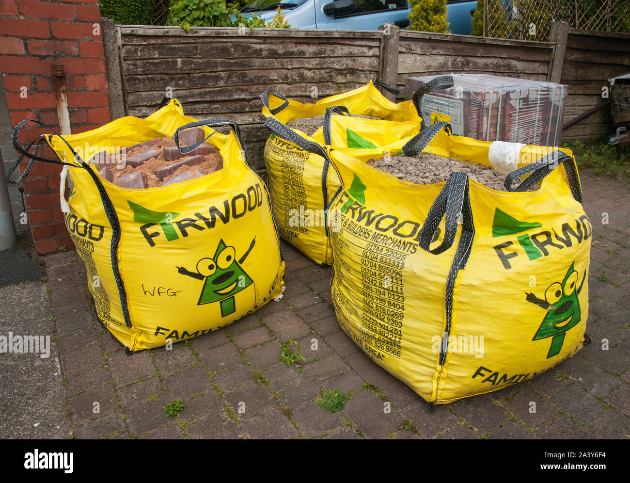 Builders bags full of building material sand and stone and a pack of ...