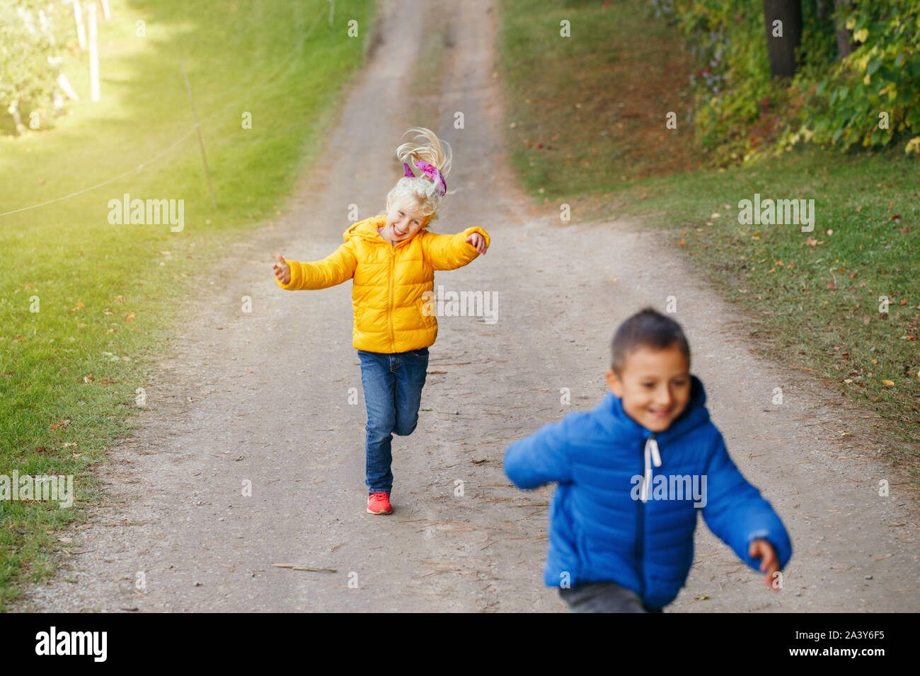 Two cute funny preschool Caucasian children boy girl running playing in ...