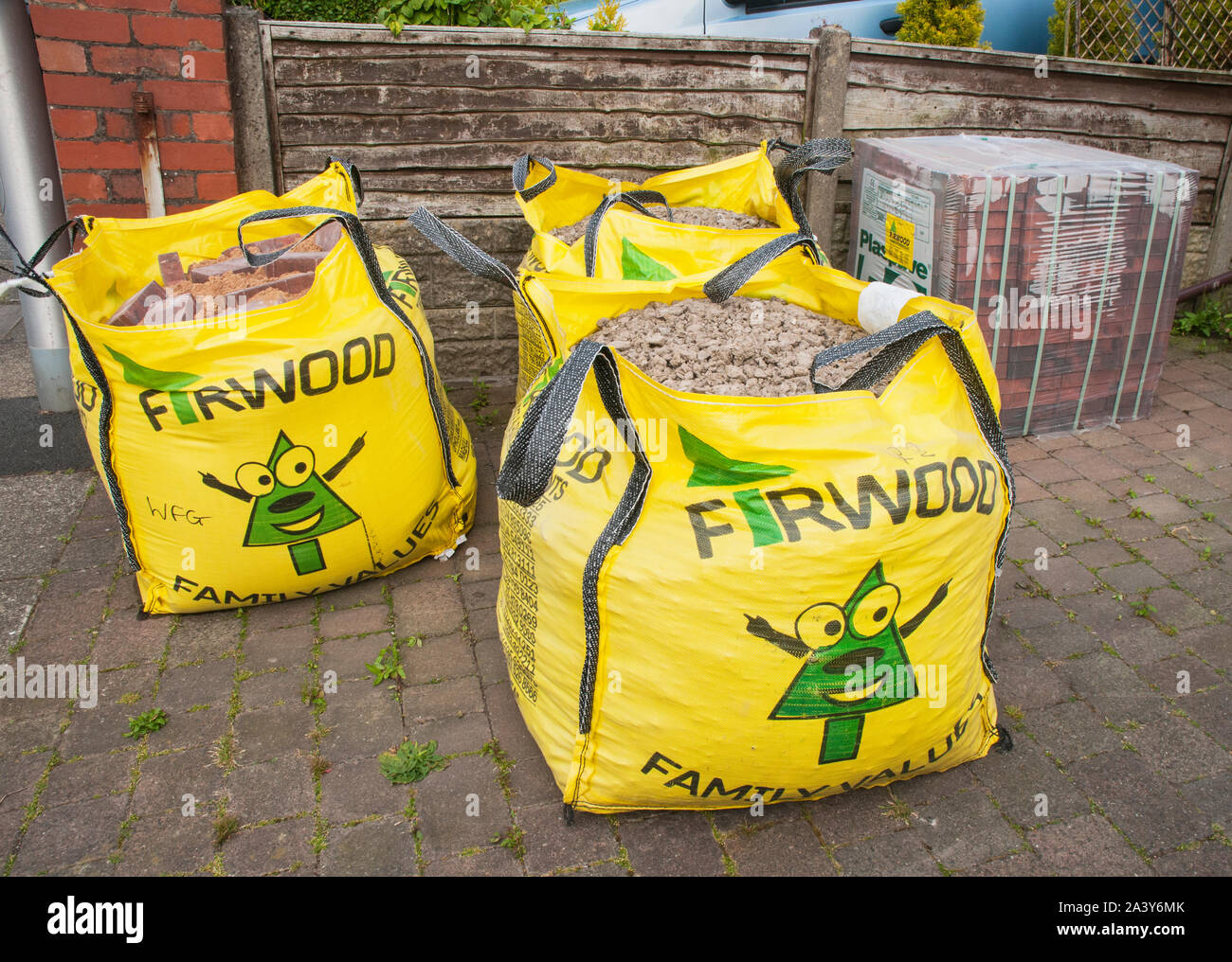 Builders bags full of building material sand and stone and a pack of ...