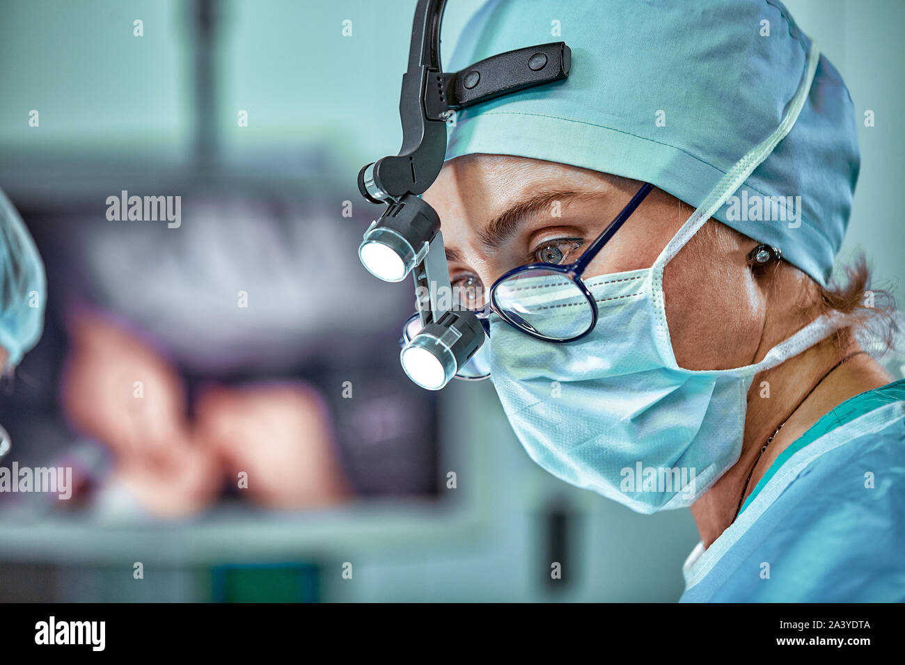 Female surgeon in operation room with reflection in glasses Stock Photo ...
