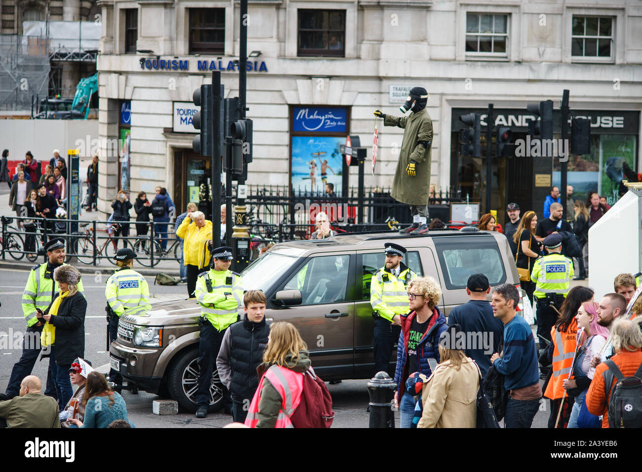 protester stands on a car surrounded by police in trafalgar square ...