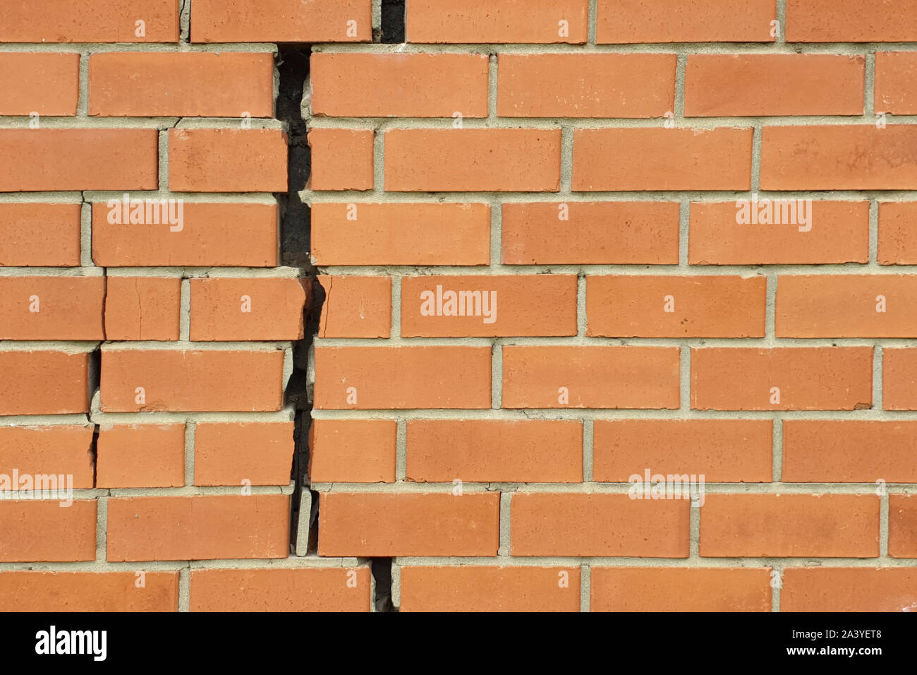 Cracked brick wall. Broken brick wall background Stock Photo - Alamy