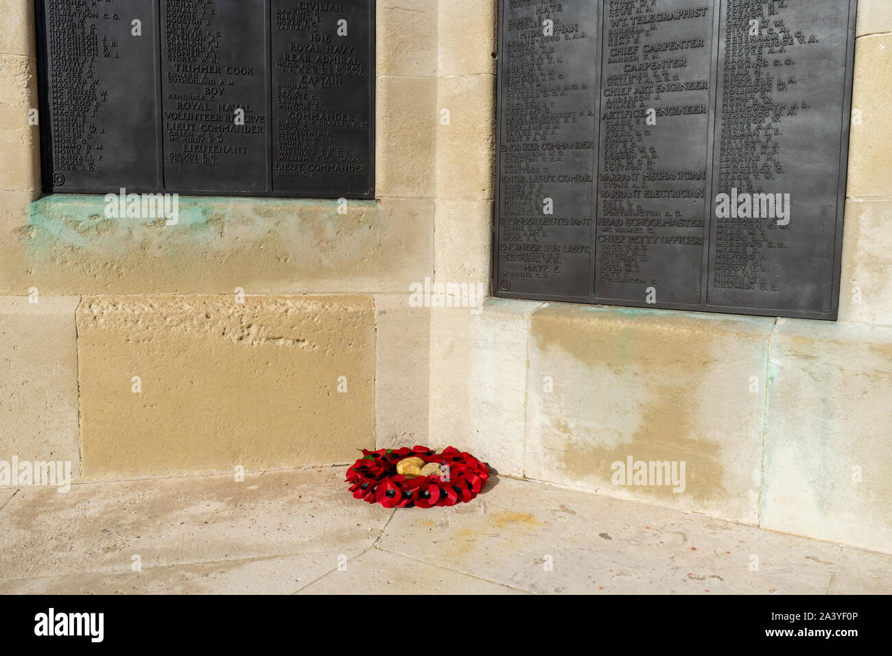 A singe red poppy wreath laid in front of the names of the war dead at ...