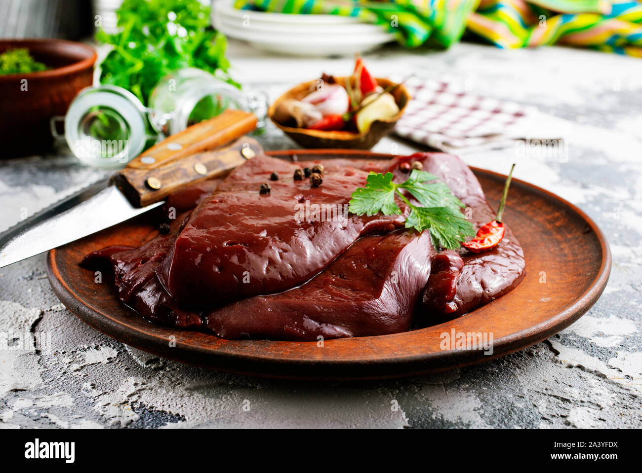 raw liver on plate on a table Stock Photo - Alamy