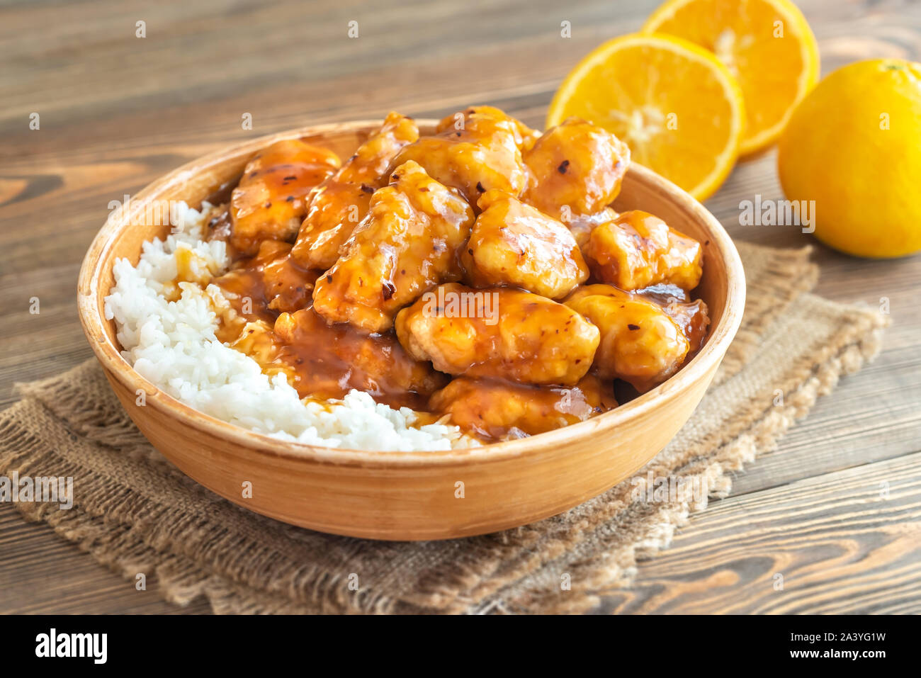 Bowl of orange chicken with white rice Stock Photo - Alamy