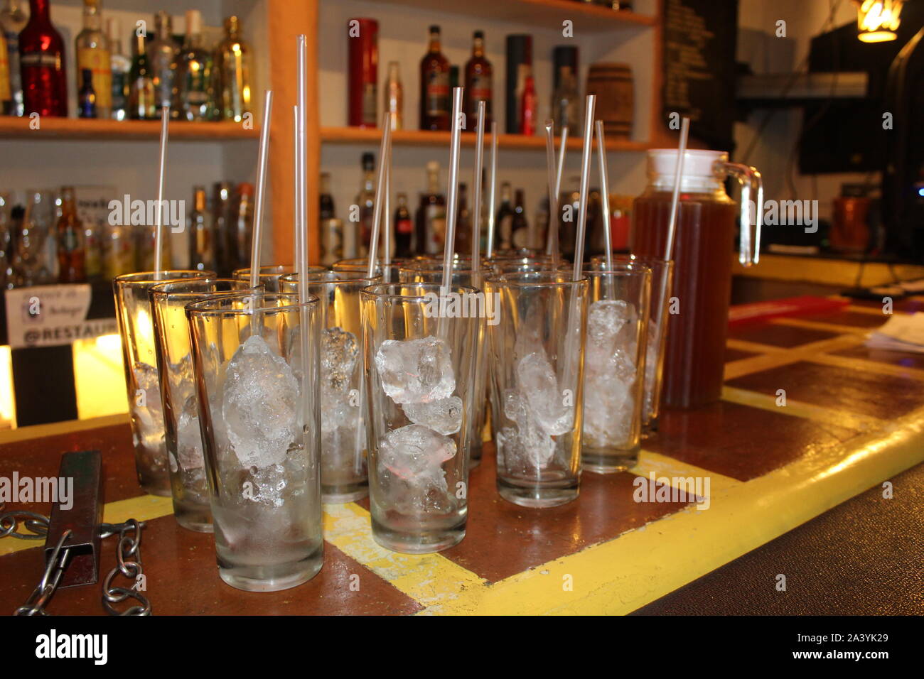 Glasses with ice on a bar counter Stock Photo - Alamy
