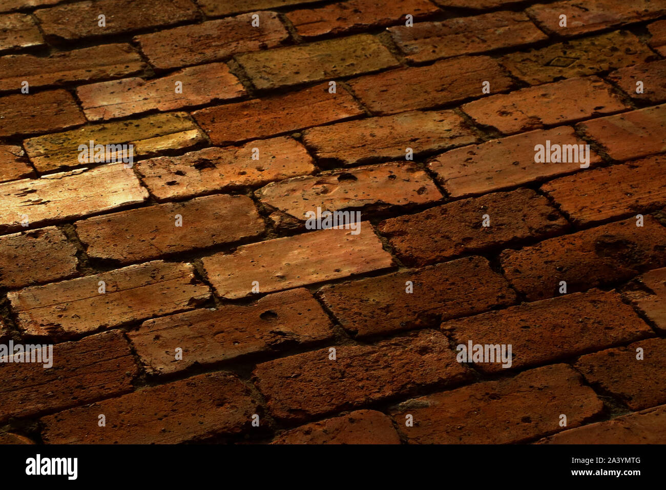 closeup of textured orange brick pathway with golden glow Stock Photo ...