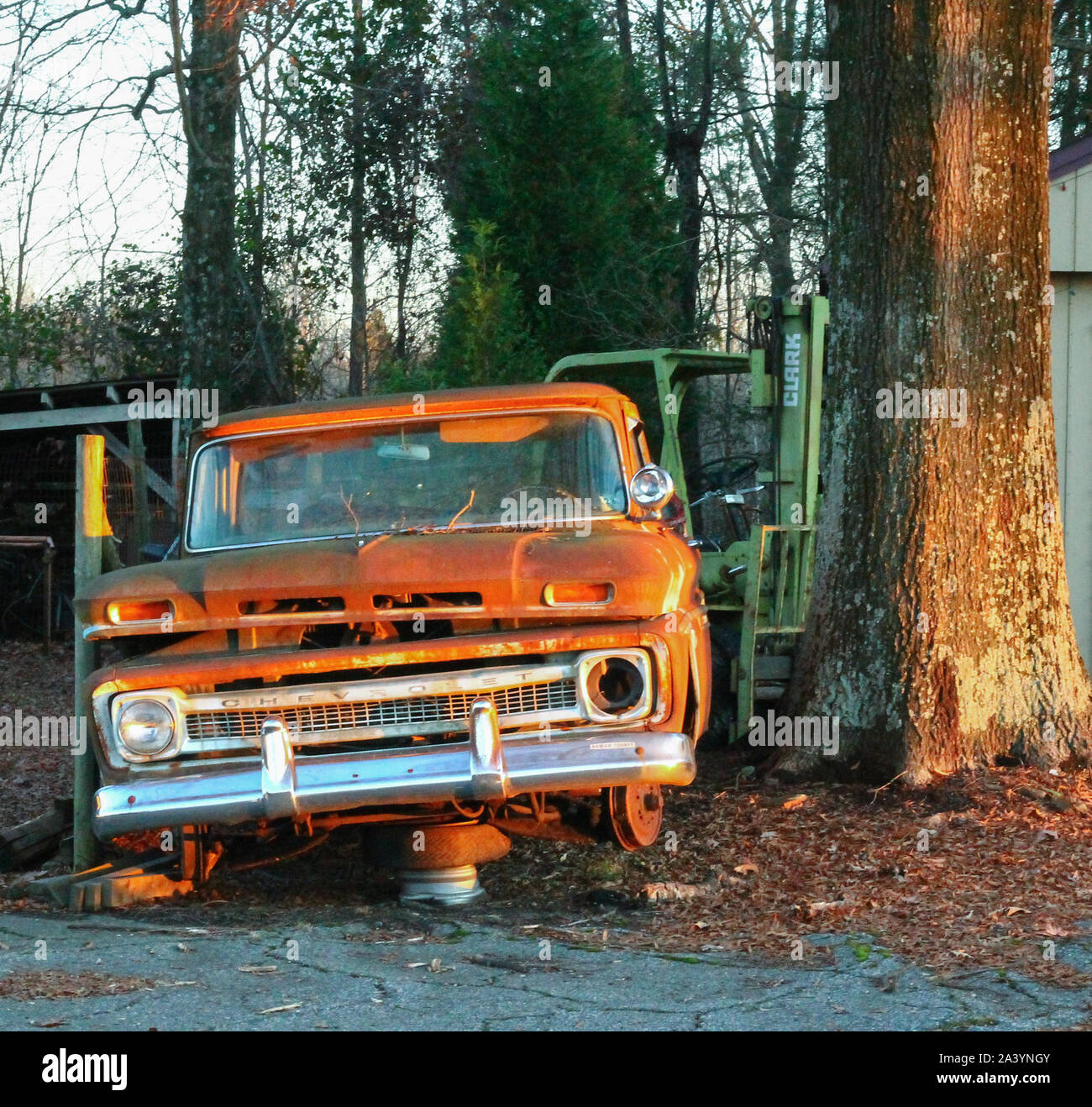 An old, rusting truck sits jacked up and forlorn in an automobile ...