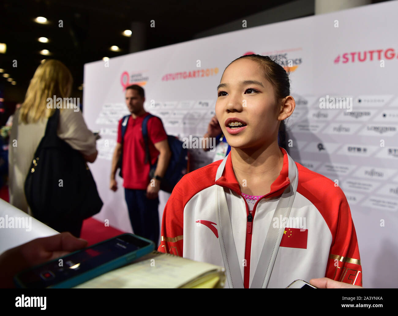 Stuttgart, Germany. 10th Oct, 2019. Tang Xijing of China receives an ...