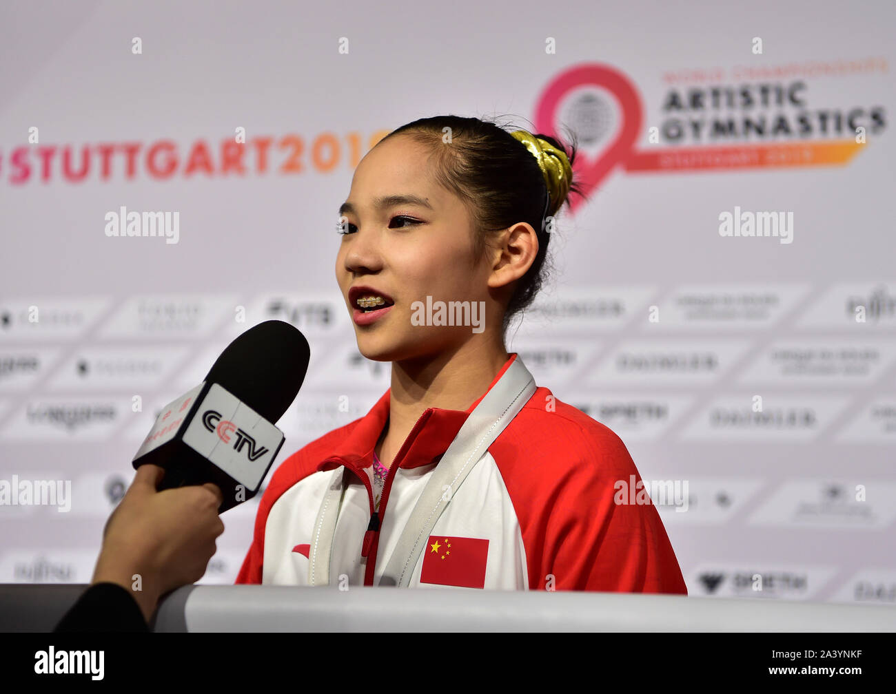 Stuttgart, Germany. 10th Oct, 2019. Tang Xijing of China receives an ...