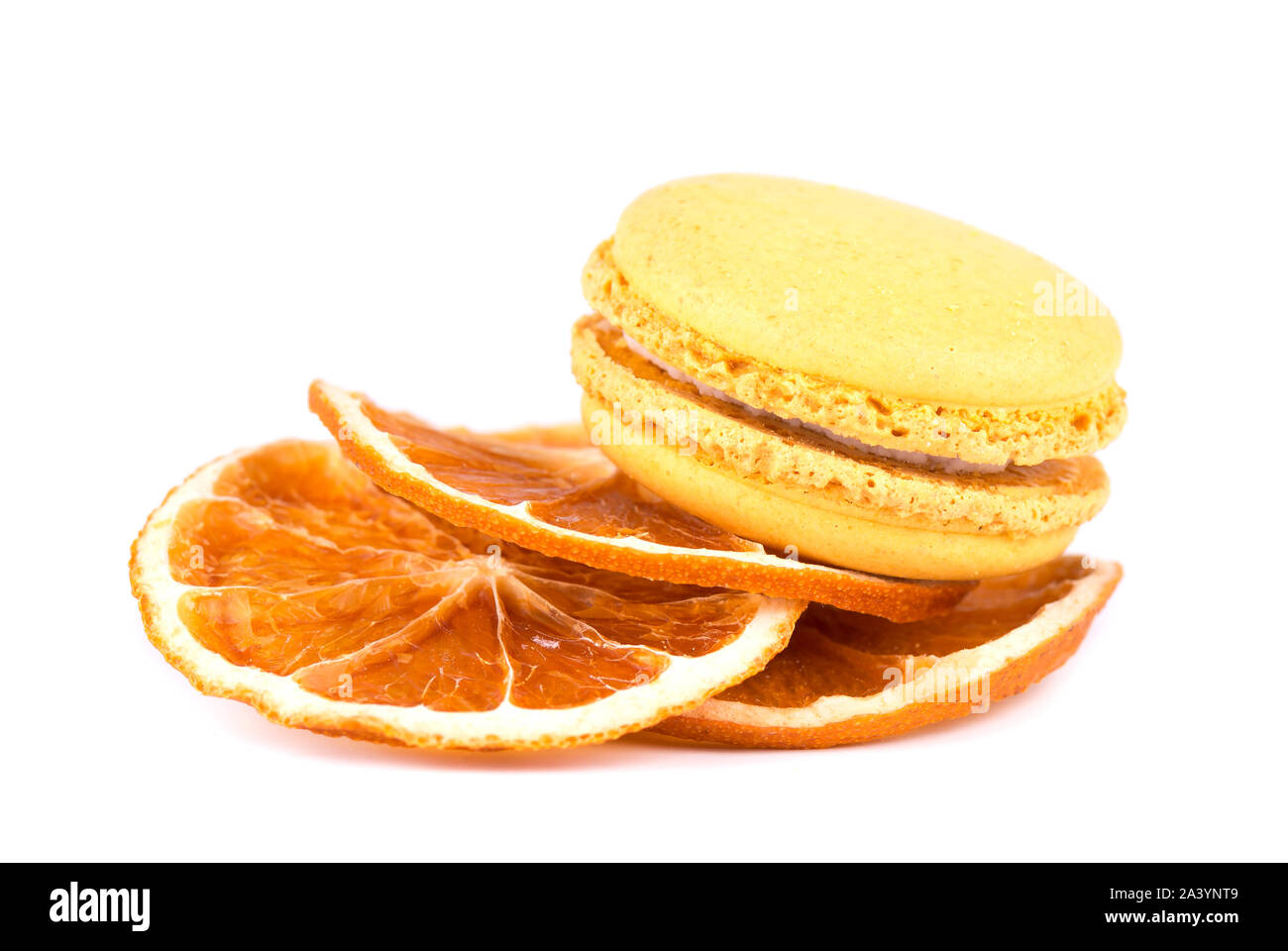 Yellow macaroons and dried orange slices, isolated on white background ...