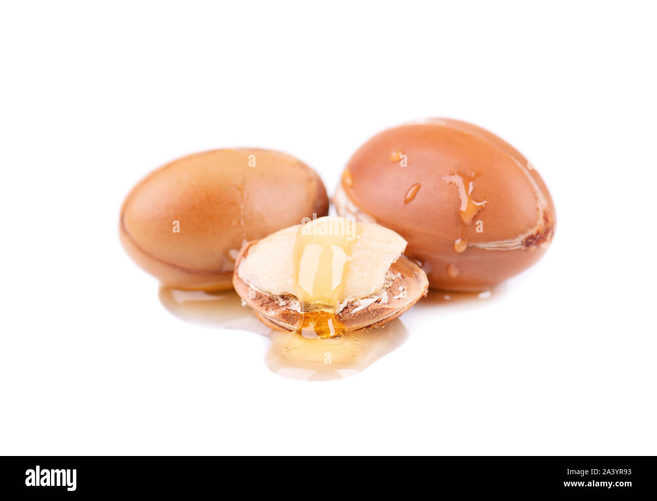 Argan seeds, isolated on a white background. Argan nuts and oil, for ...