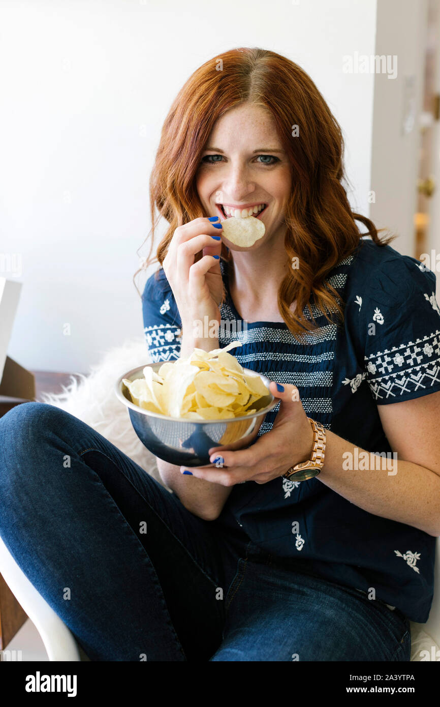 Woman eating crisps hi-res stock photography and images - Alamy