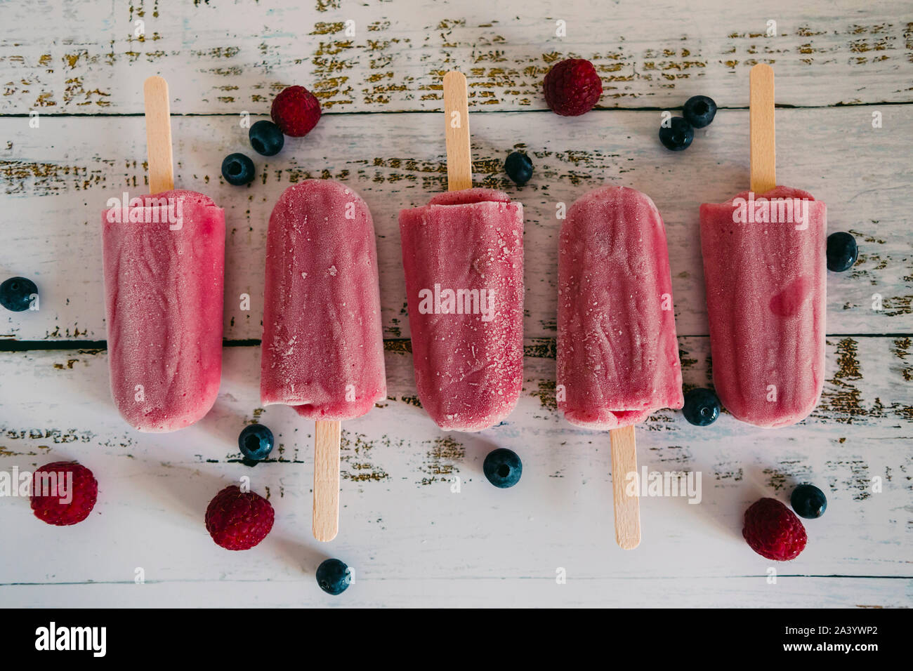 Row of berry ice pops with berries Stock Photo - Alamy