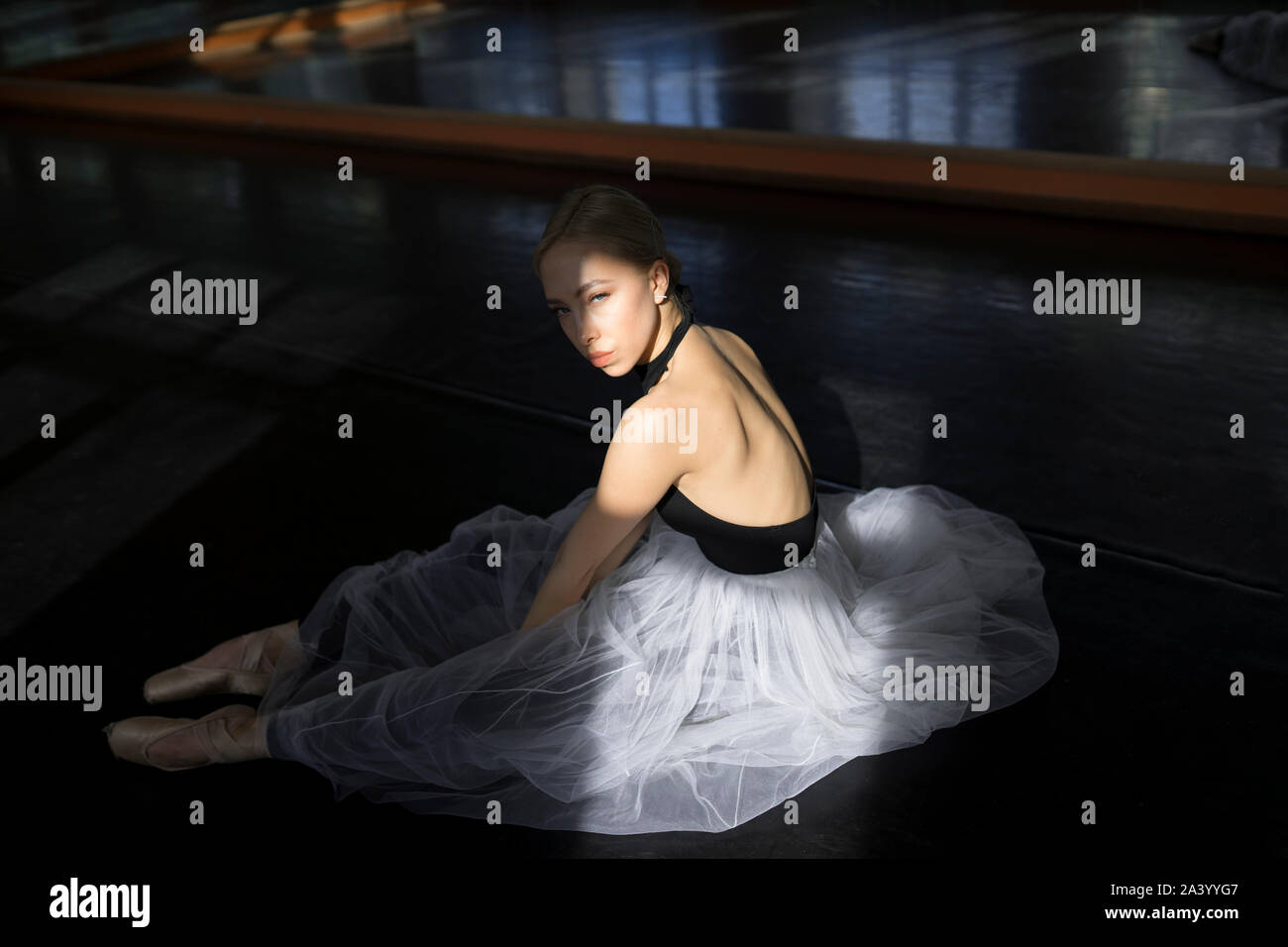 Ballet dancer sitting in shadow Stock Photo - Alamy