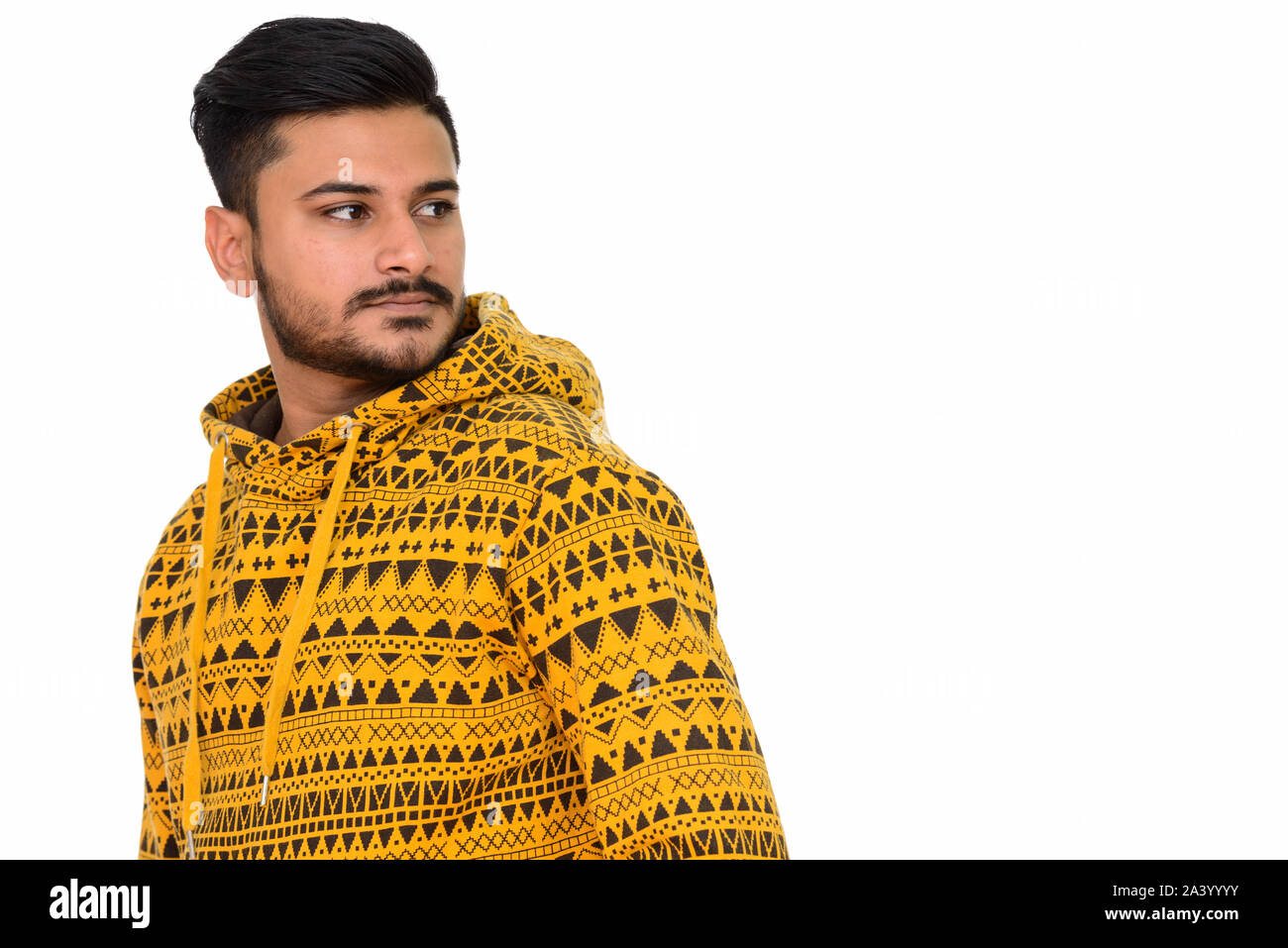 Young handsome Indian man looking back isolated against white ...