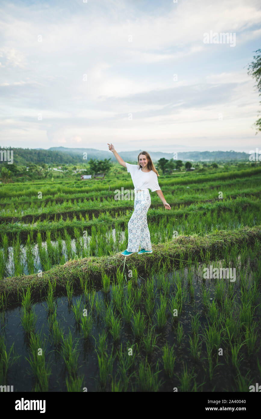 Woman walking in rice paddy in Bali, Indonesia Stock Photo - Alamy