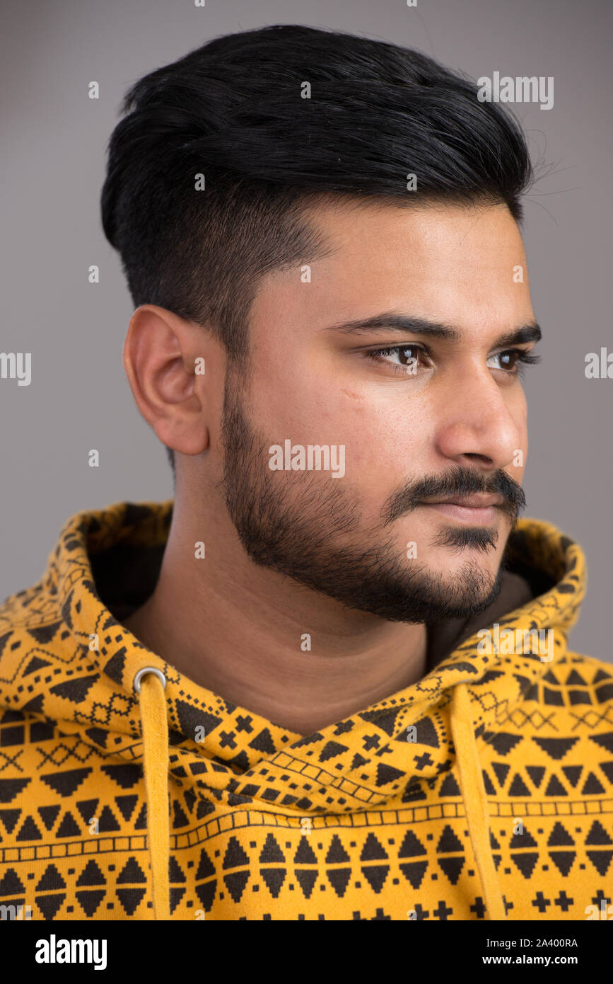 Face of young handsome Indian man thinking Stock Photo - Alamy