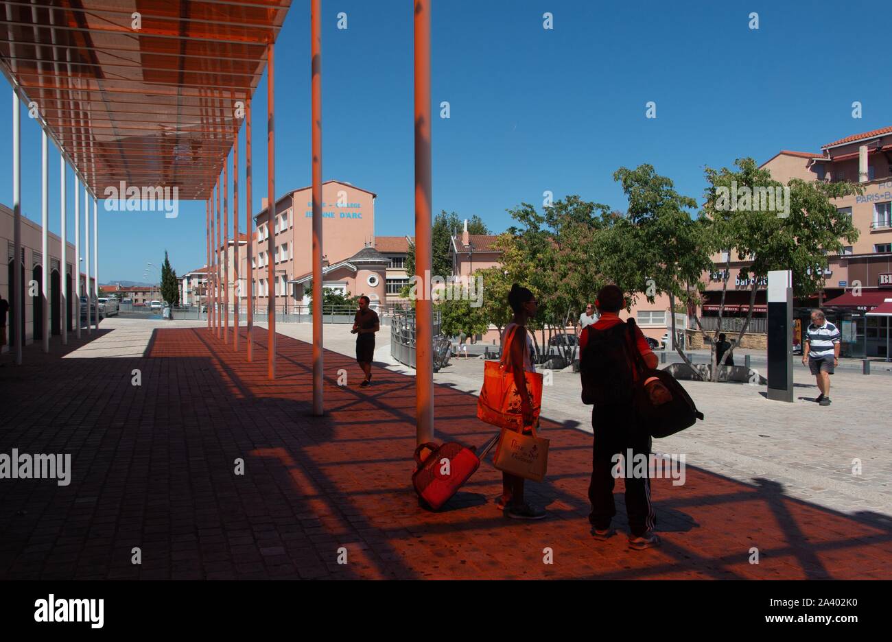 PASSENGERS IN FRONT OF THE PERPIGNAN TRAIN STATION, THE CENTER OF THE ...
