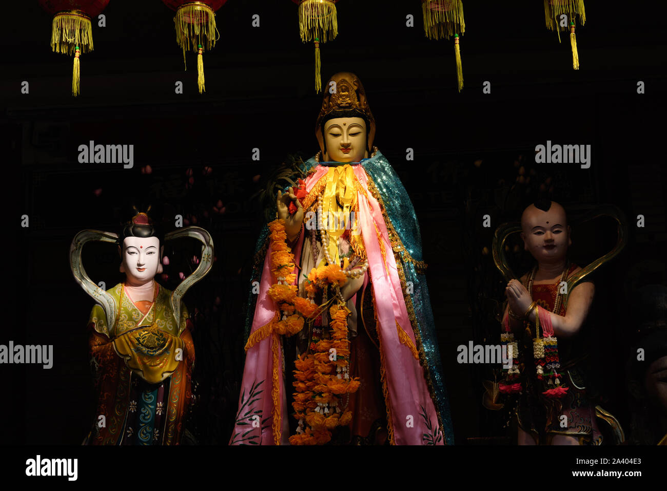 Early morning sunlight lights up statues in a Taoist prayer shrine ...