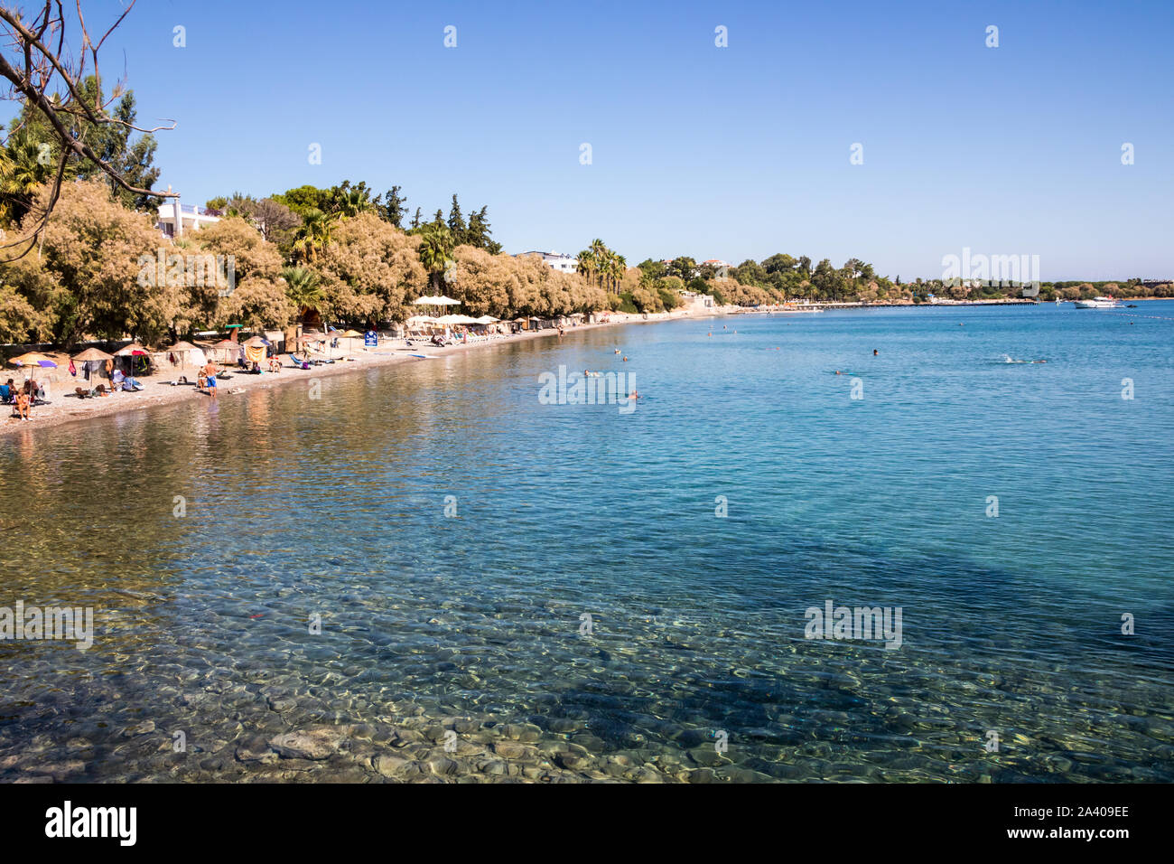 People swimming and sunbathing on Hastane Alti beach, Datca, Turkey ...