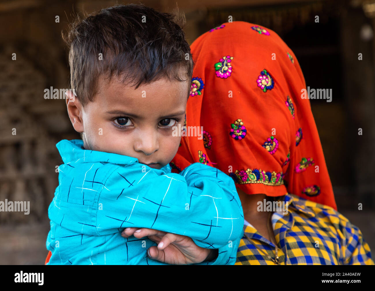 Indian mother with face covered by a sari with her son, Rajasthan ...